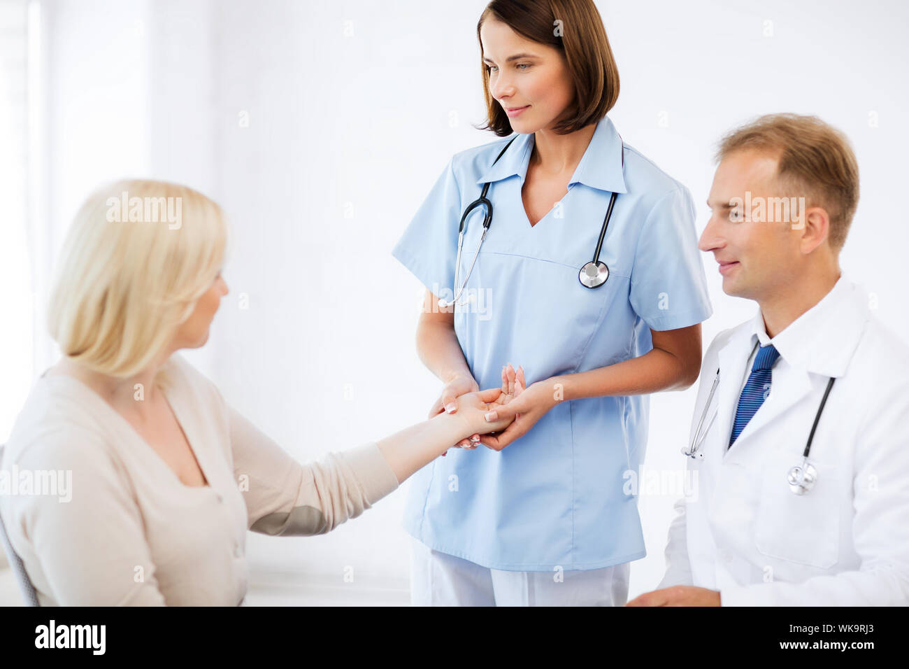 nurse with patient measuring pulse Stock Photo - Alamy