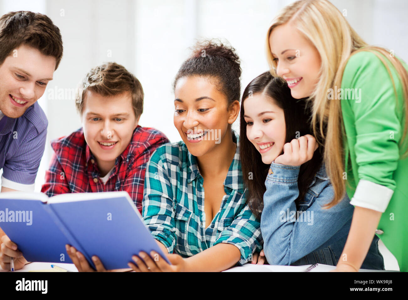 students reading book at school Stock Photo - Alamy