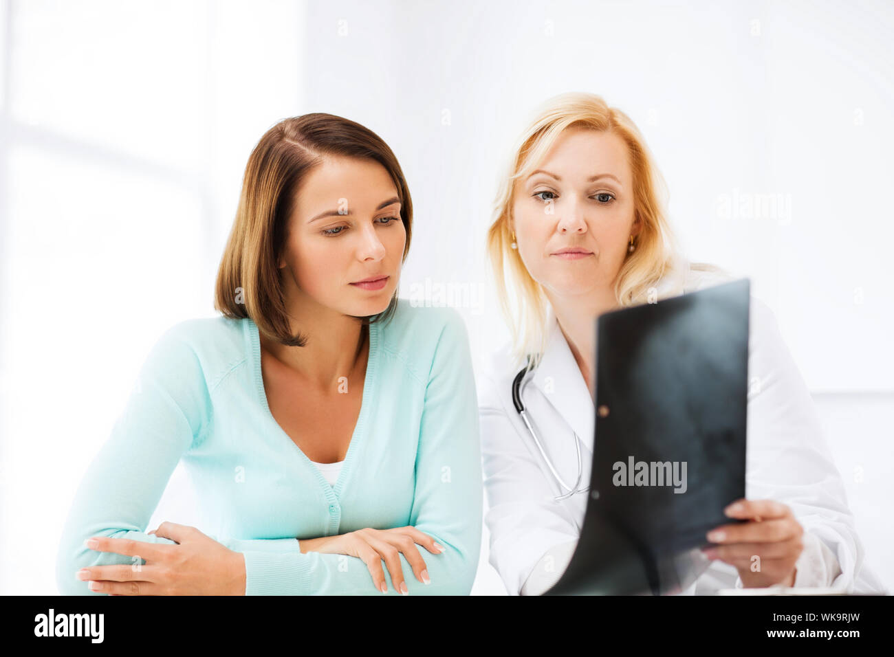 doctor with patient looking at x-ray Stock Photo - Alamy