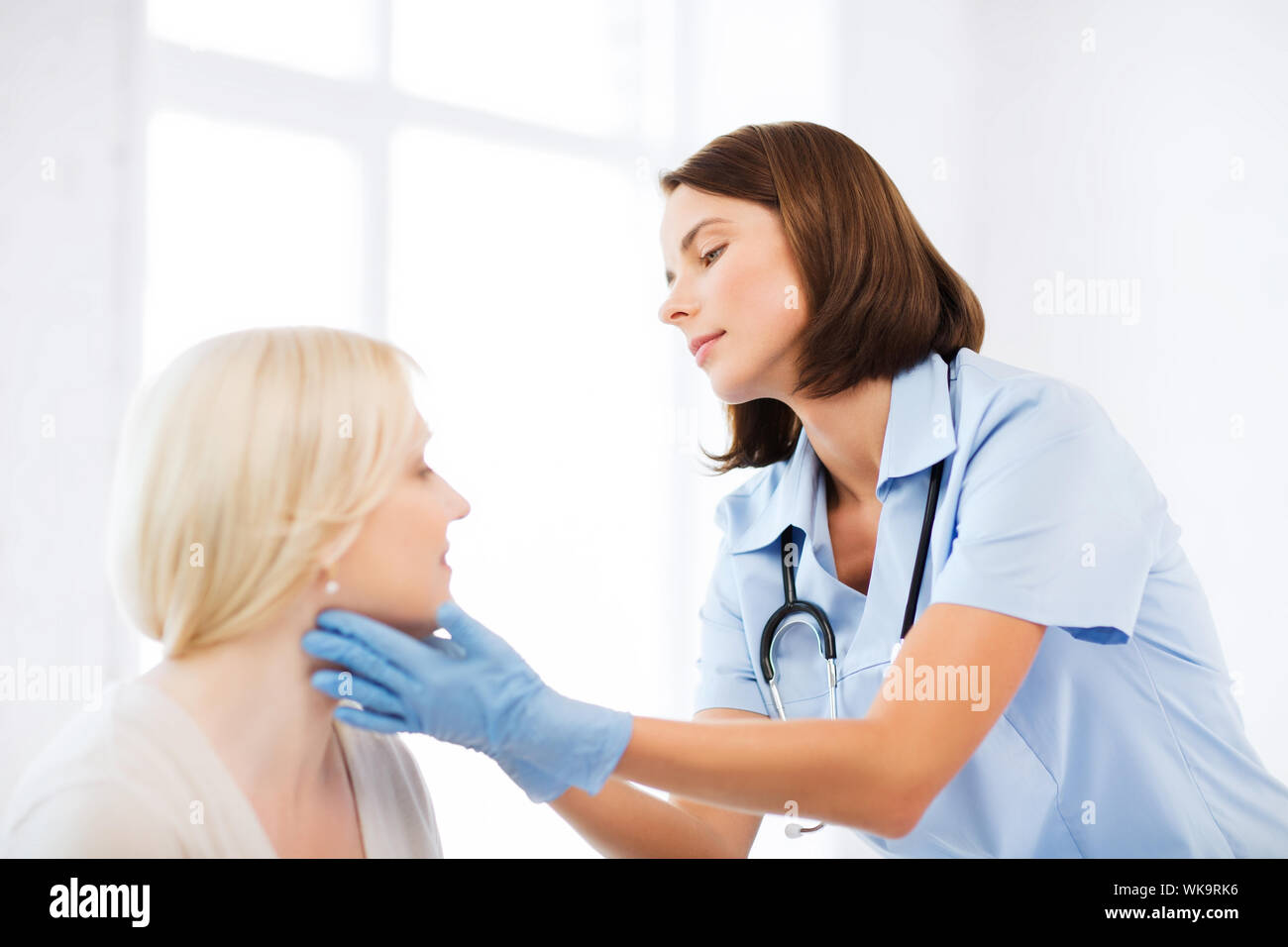 plastic surgeon or doctor with patient Stock Photo - Alamy