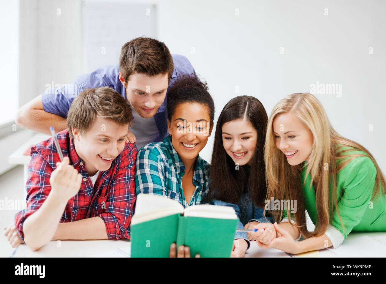 students reading book at school Stock Photo - Alamy