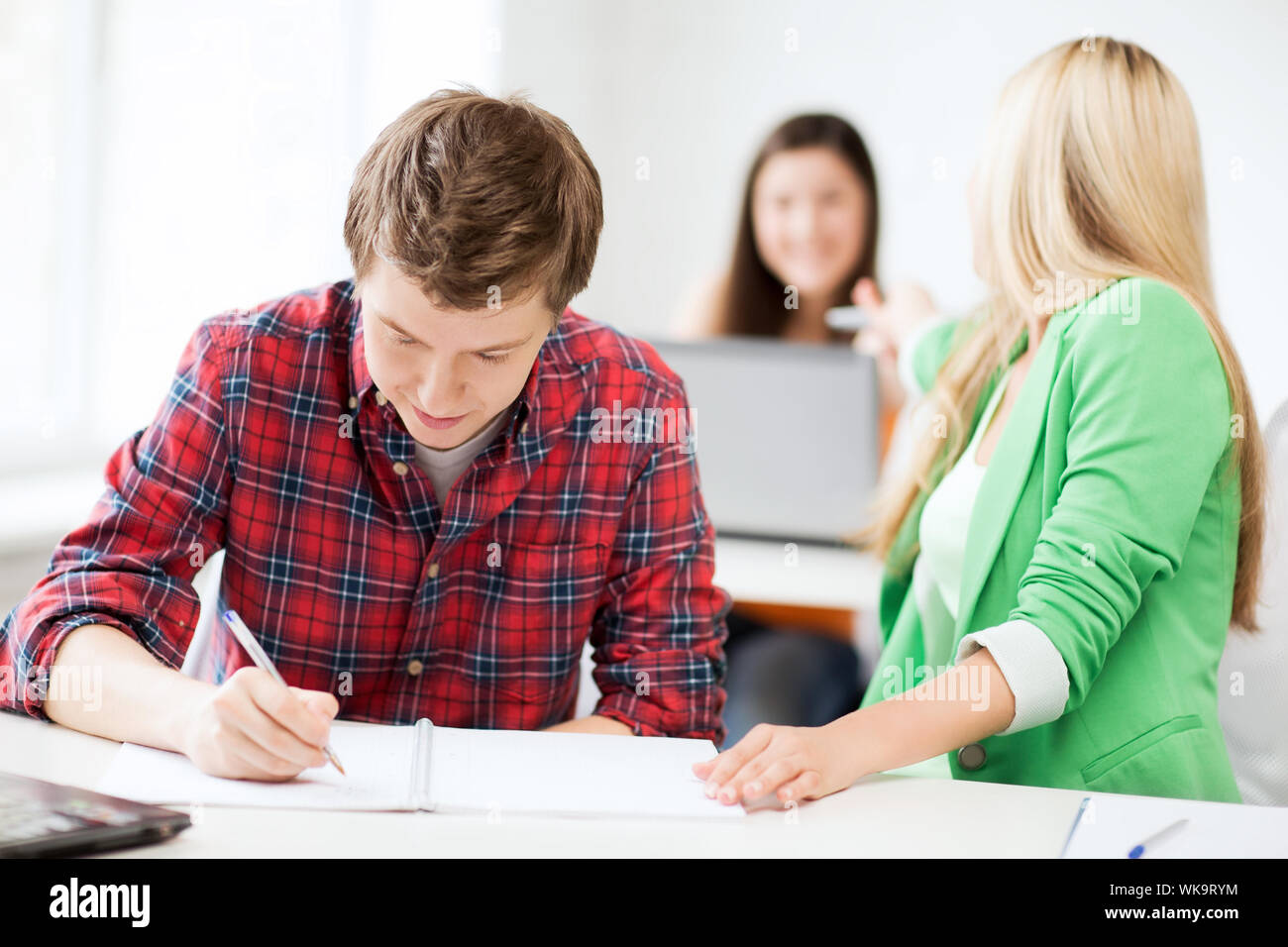 education concept - students writing something at school Stock Photo ...
