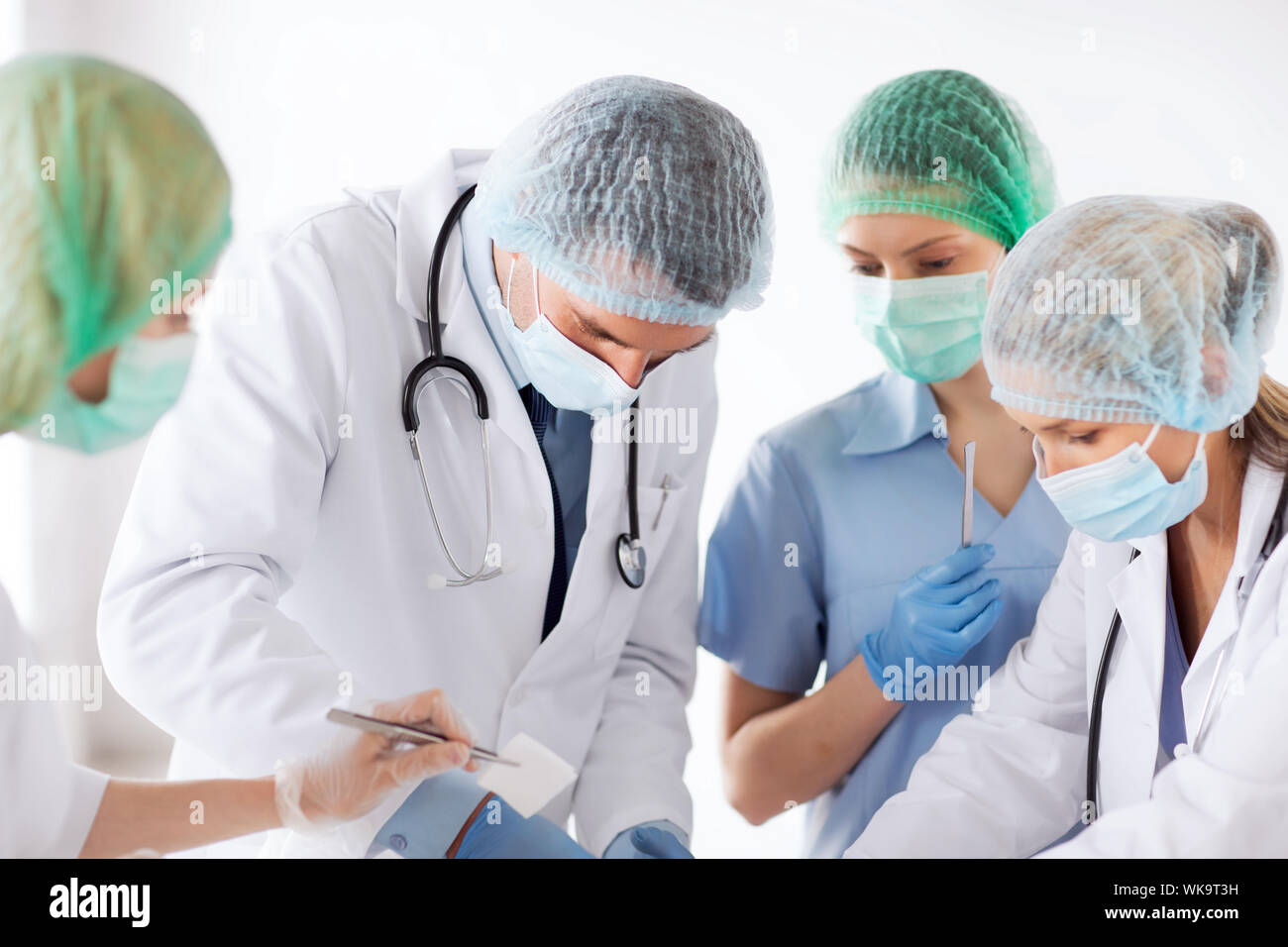 healthcare and medical - young group of doctors doing operation Stock ...