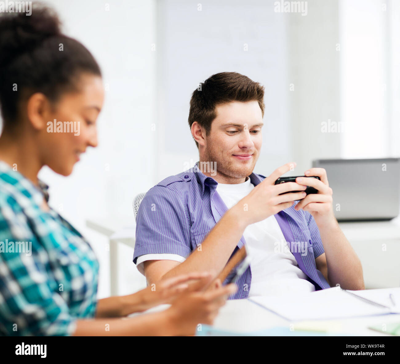 students looking at devices at school Stock Photo - Alamy