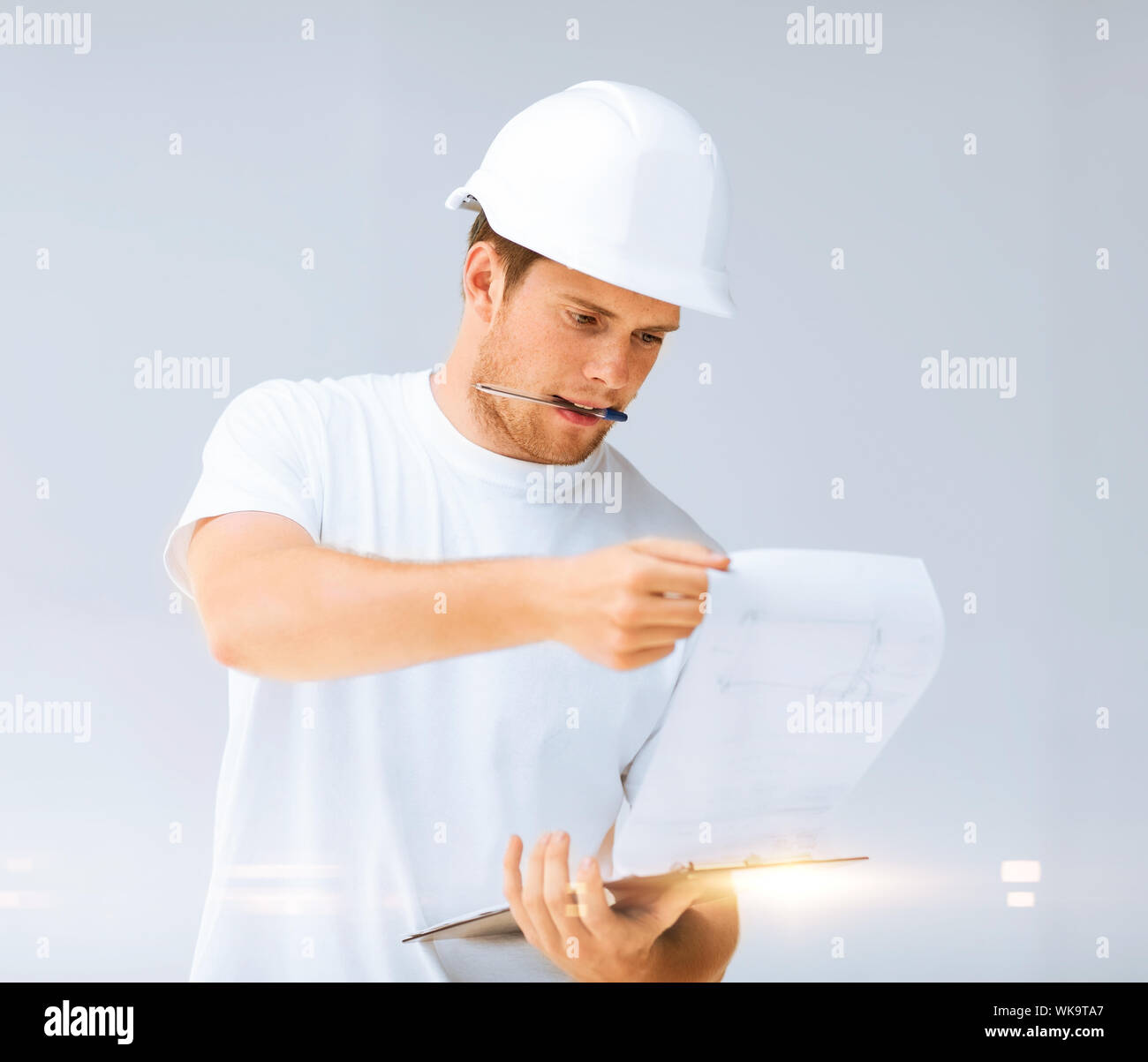 male architect looking at blueprint Stock Photo - Alamy