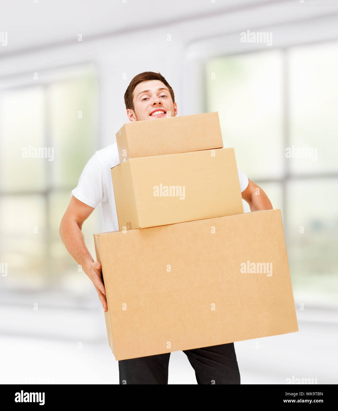 home, postal service and delivery - young man carrying carton boxes ...