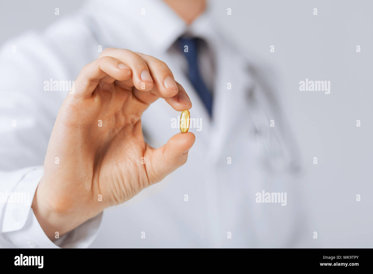 doctor hand showing one capsule Stock Photo - Alamy