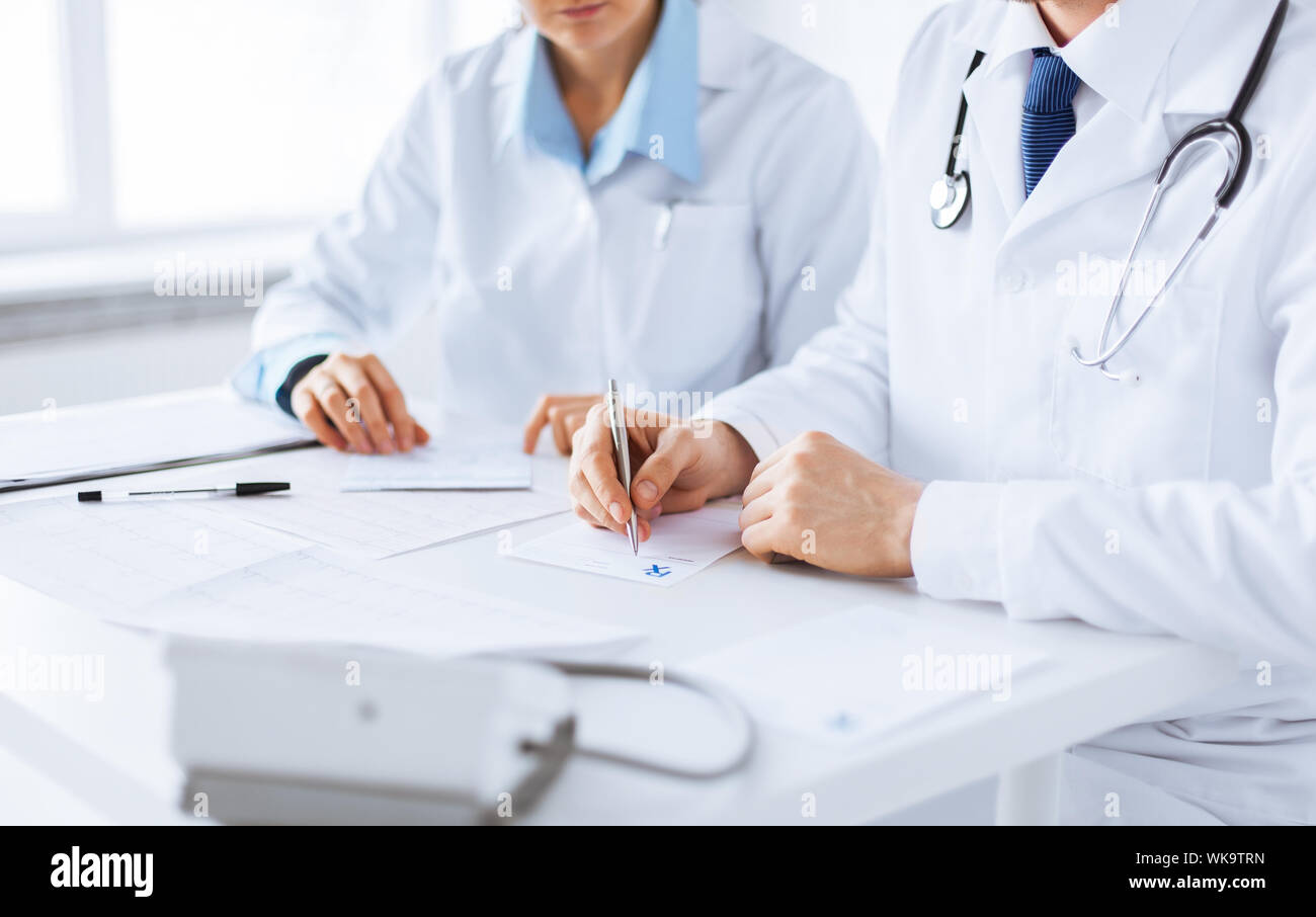 doctor and nurse writing prescription paper Stock Photo - Alamy
