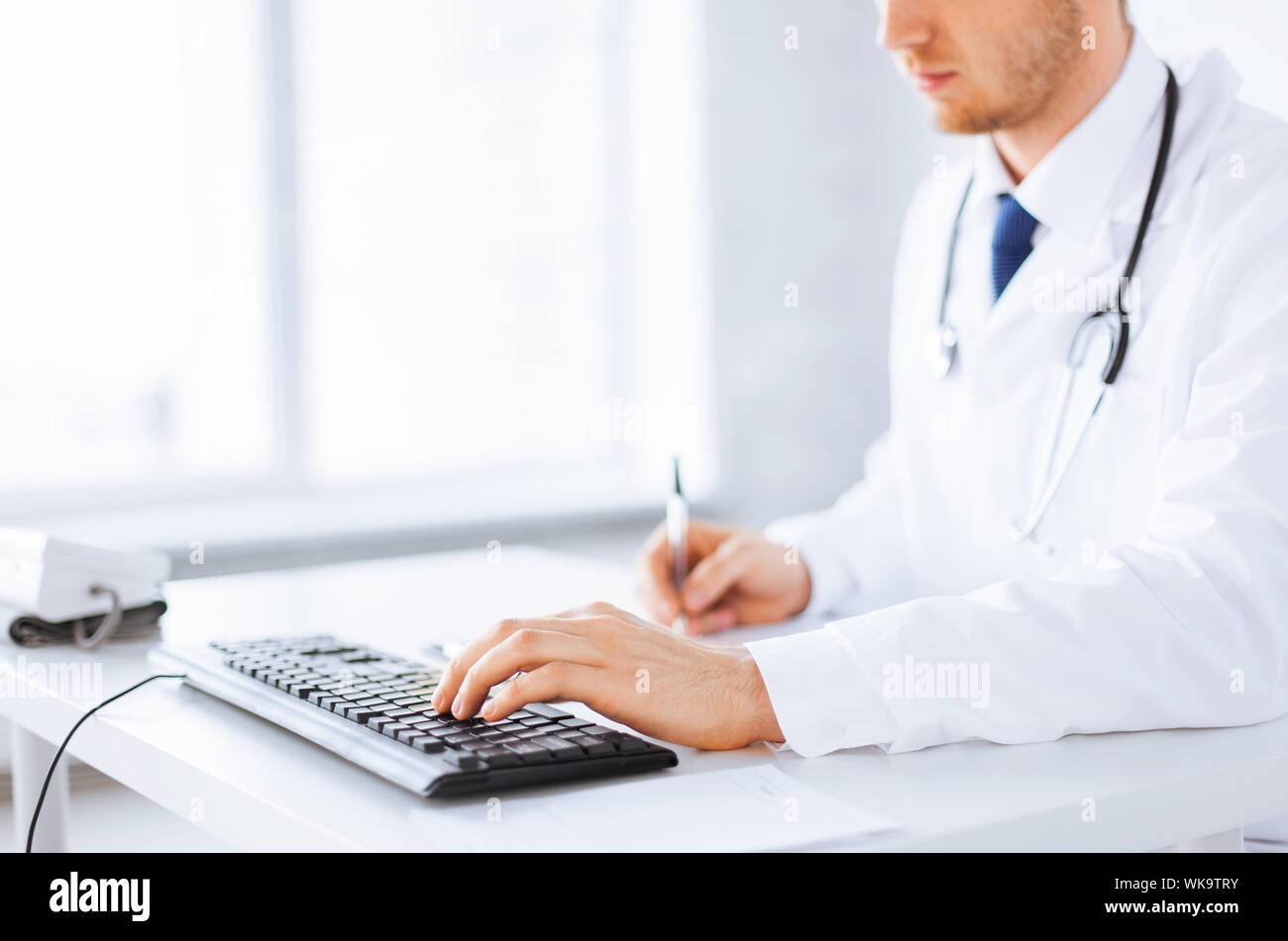 male doctor typing on the keyboard Stock Photo - Alamy