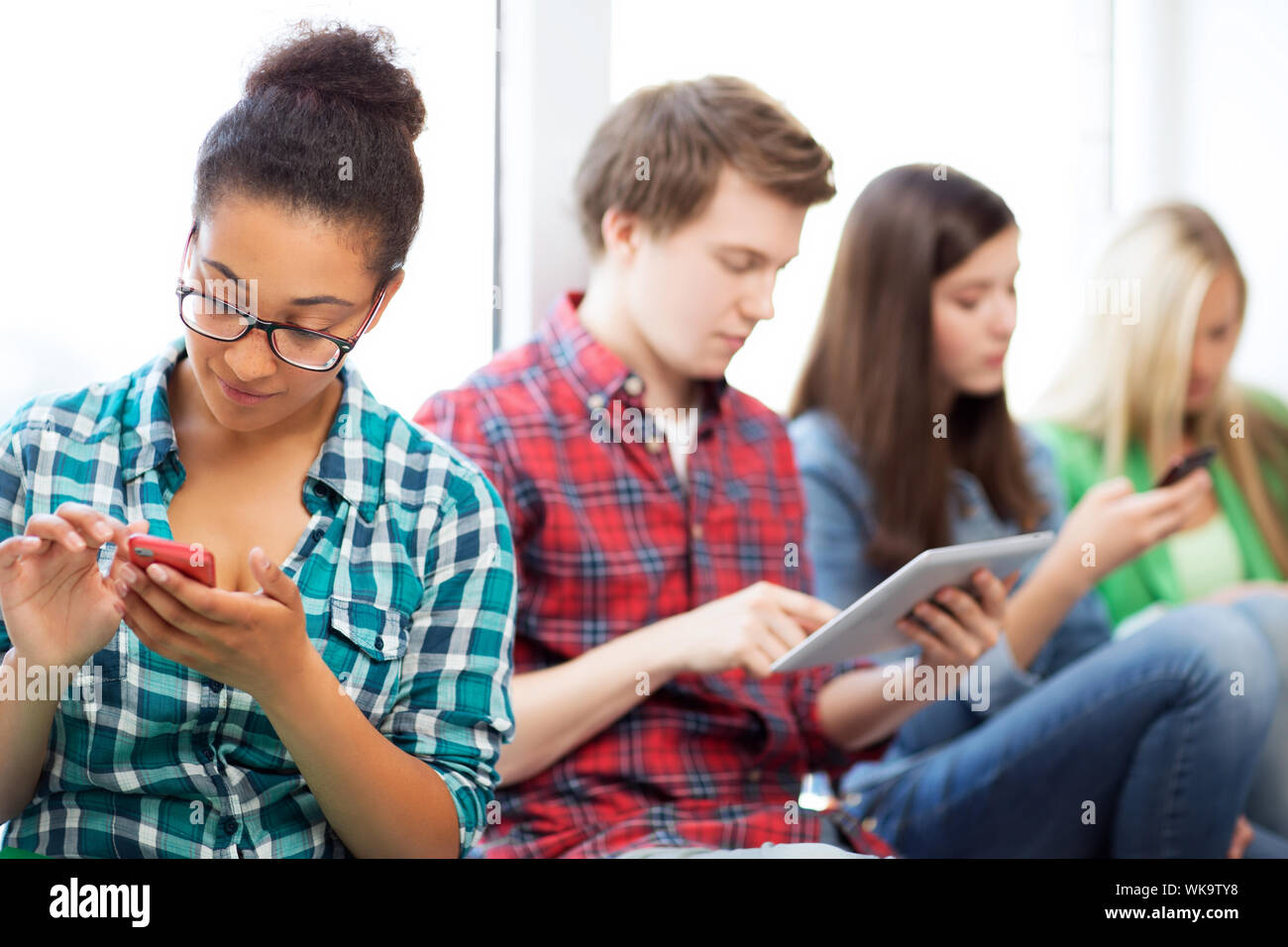 students looking into devices at school Stock Photo - Alamy
