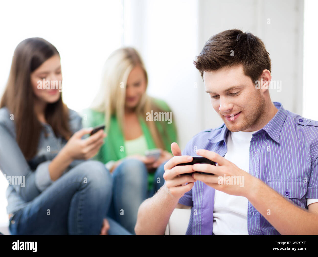students looking into devices at school Stock Photo - Alamy