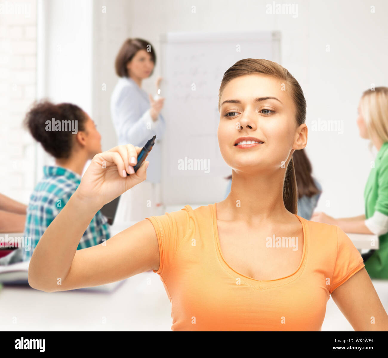 student writing something in the air with marker Stock Photo - Alamy