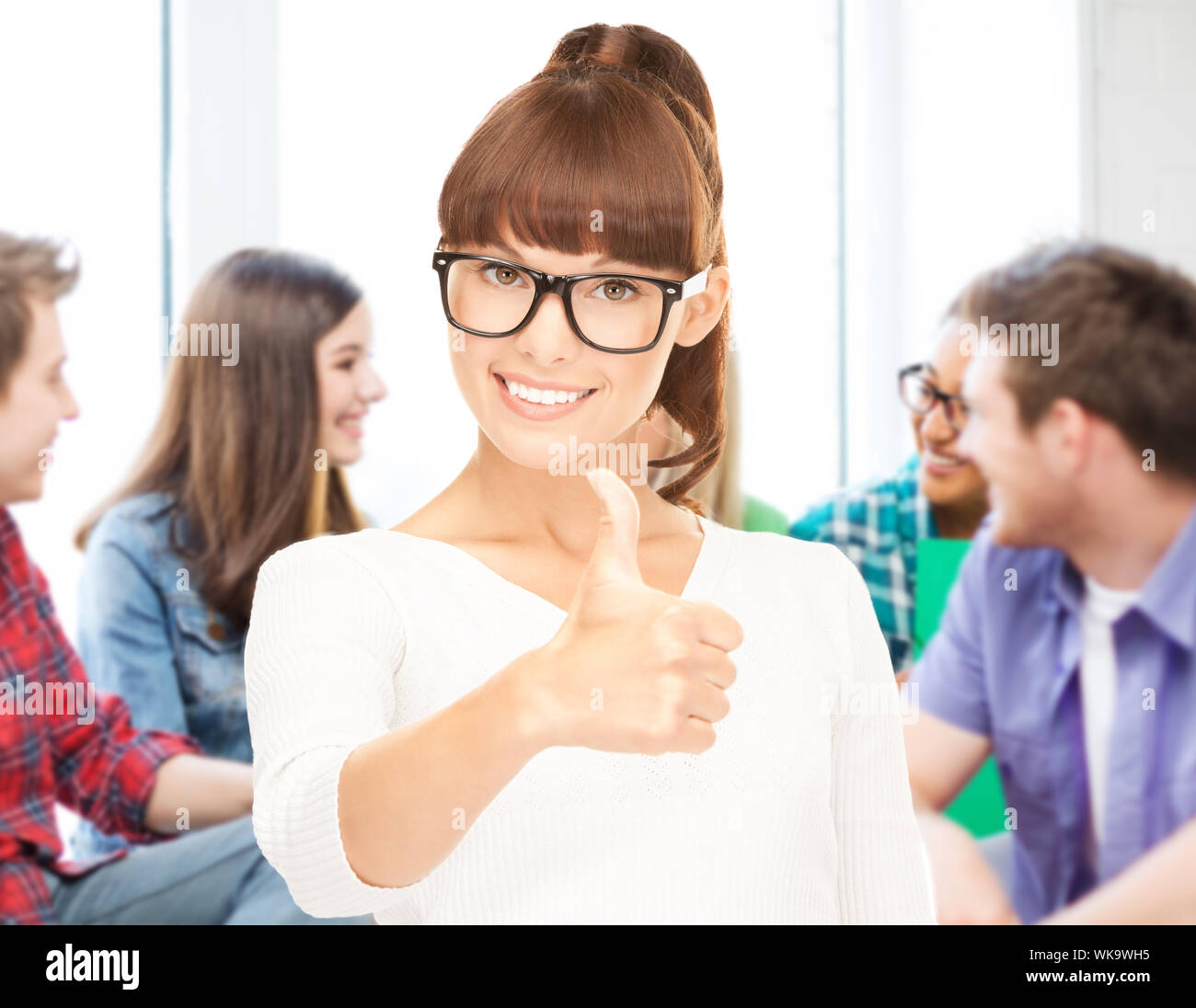 student showing thumbs up at school Stock Photo - Alamy