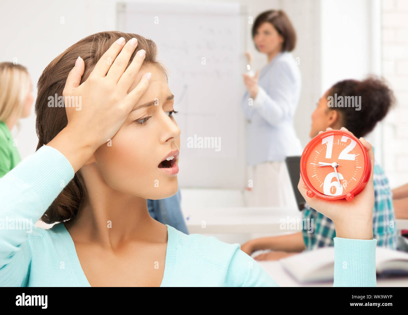 attractive student looking at clock Stock Photo - Alamy