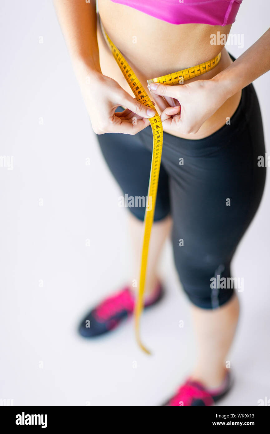 trained belly with measuring tape Stock Photo - Alamy