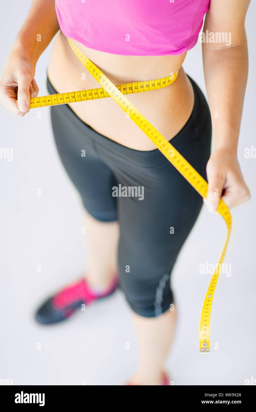 trained belly with measuring tape Stock Photo - Alamy
