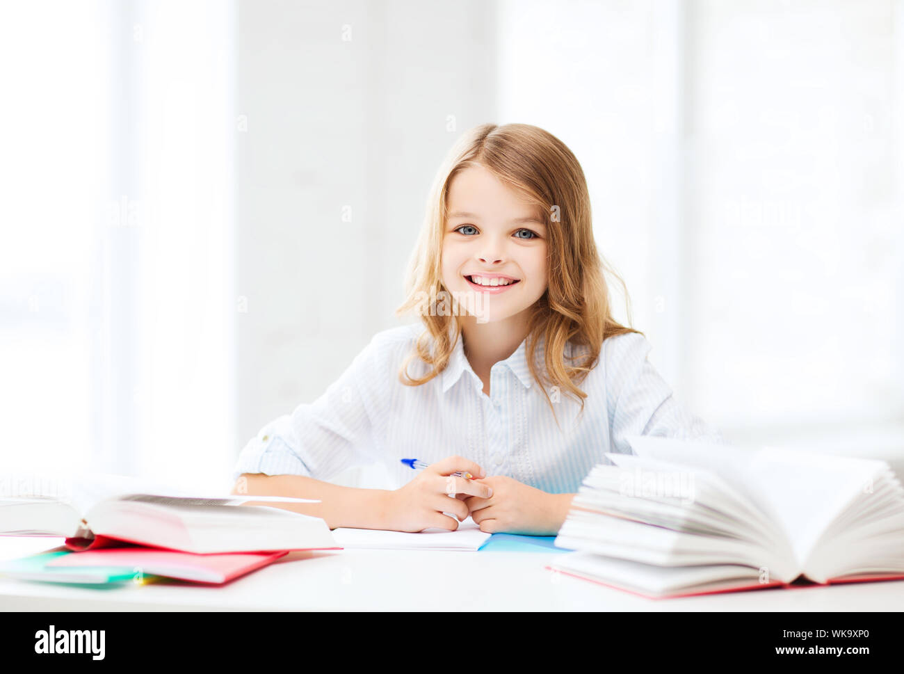 education and school concept - little student girl studying at school ...
