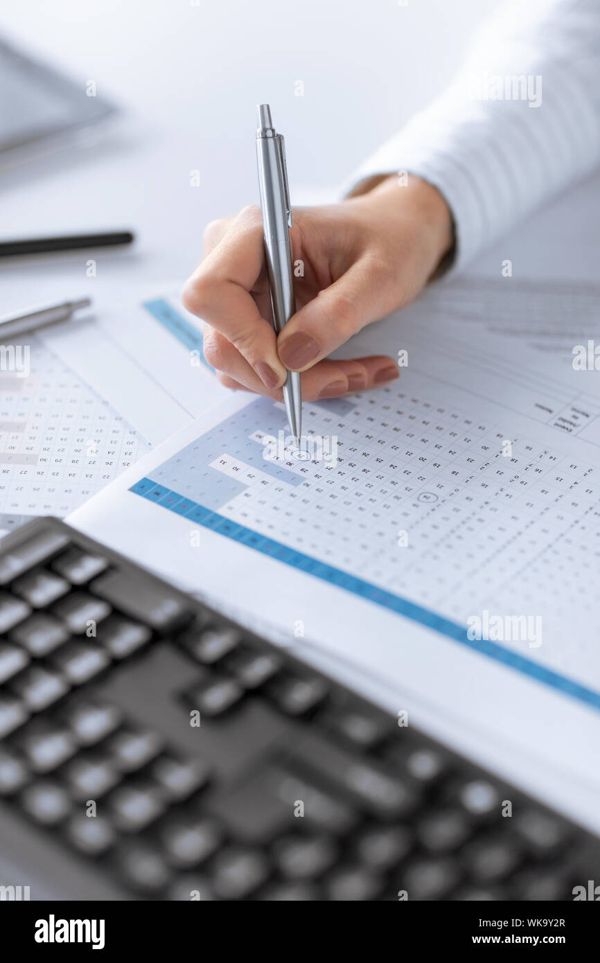woman hand writing on paper with numbers Stock Photo - Alamy