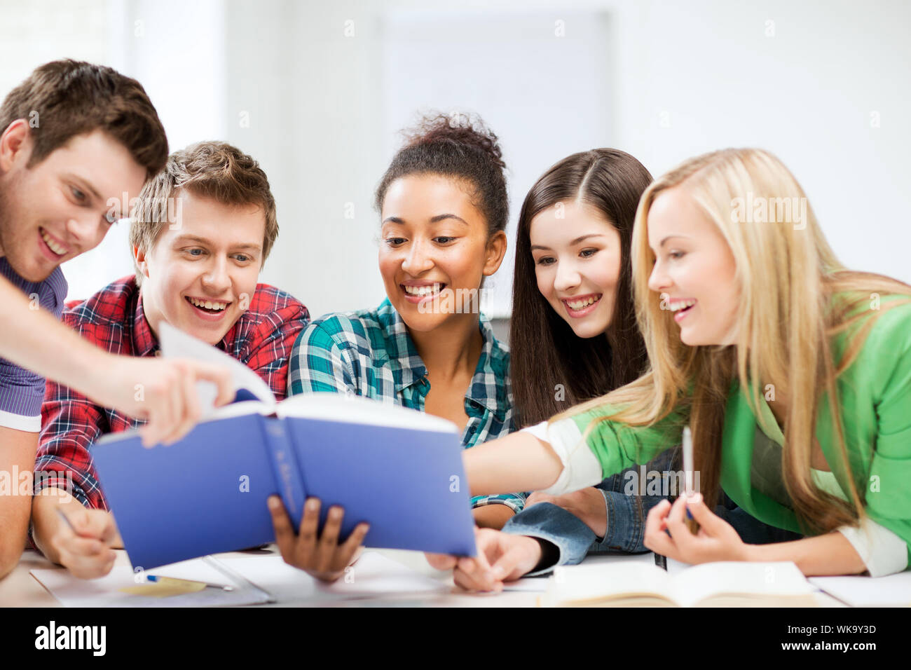 students reading book at school Stock Photo - Alamy