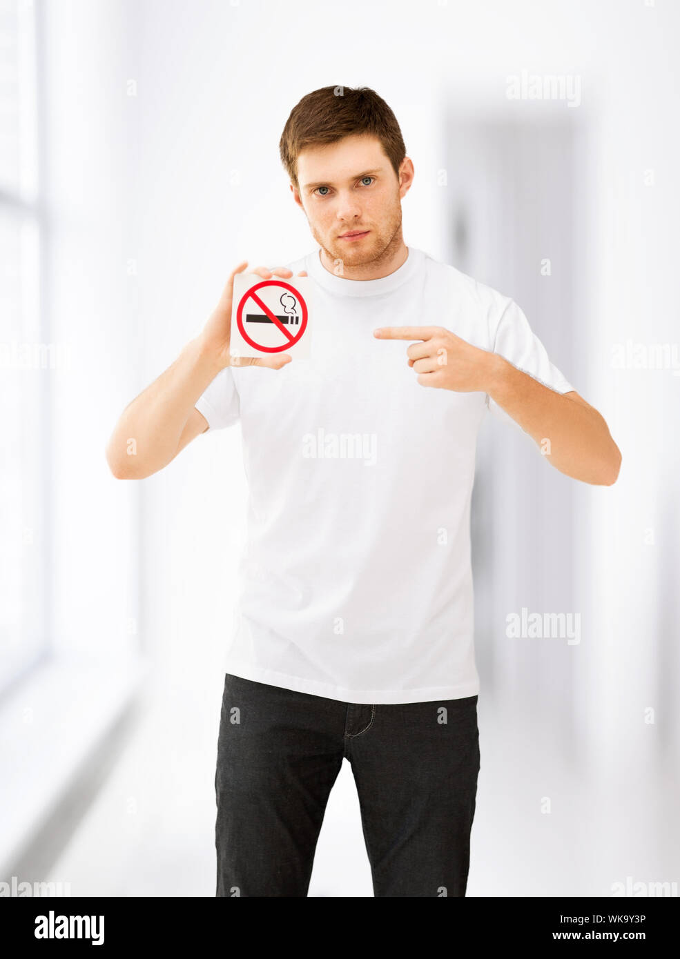 picture of young man pointing at no smoking sign Stock Photo - Alamy