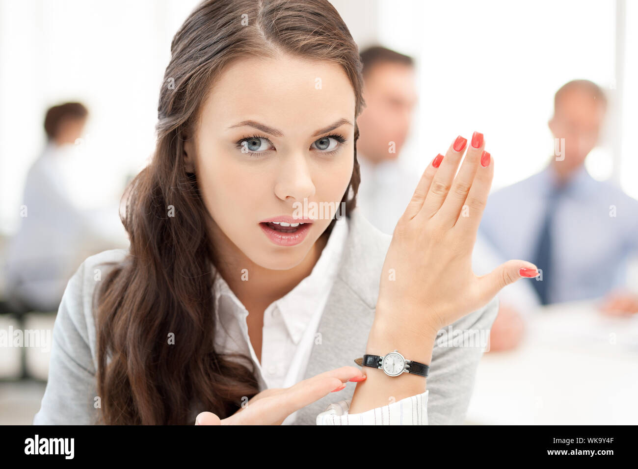business and time management concept - businesswoman pointing at her ...
