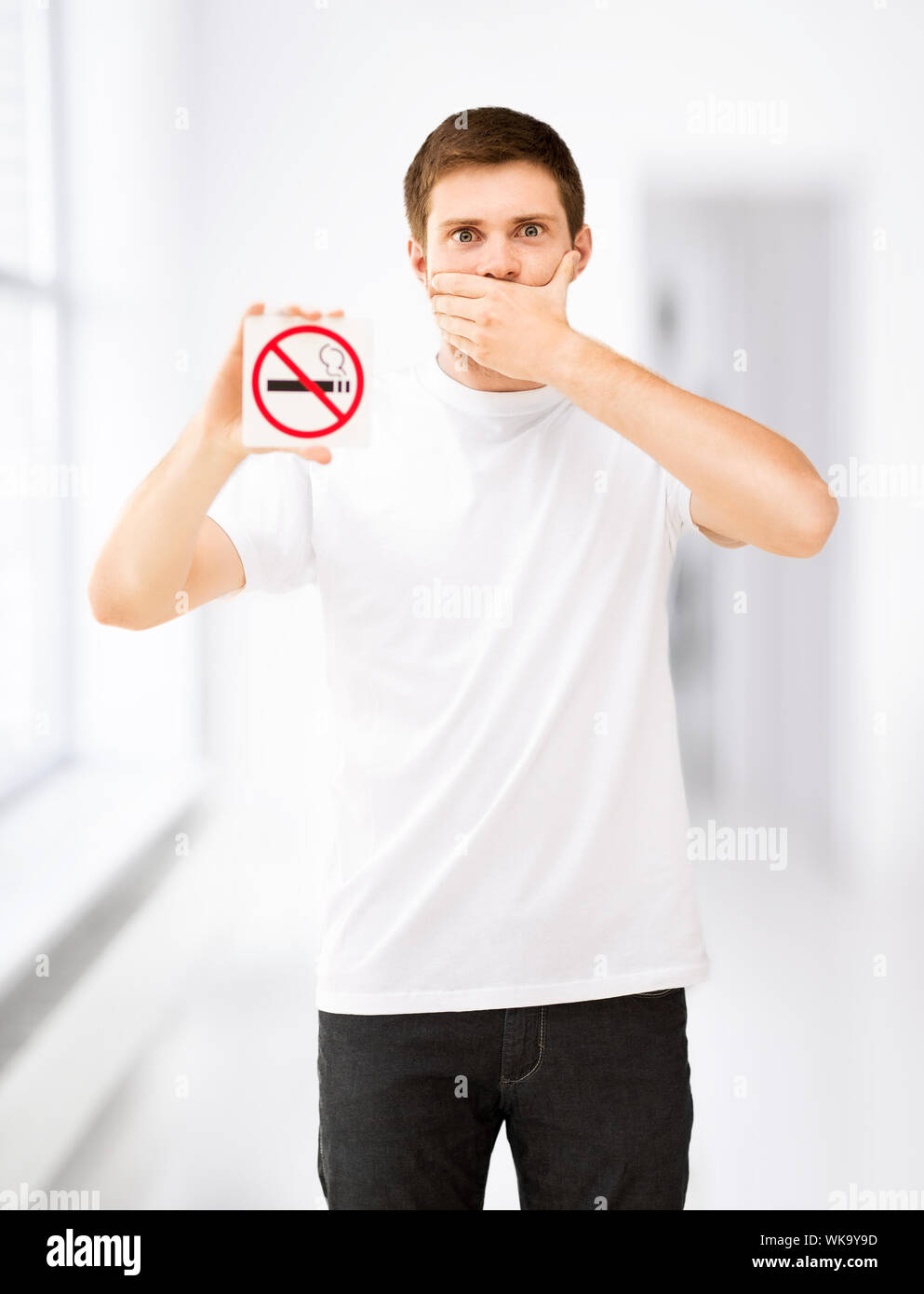 picture of young man holding no smoking sign Stock Photo - Alamy