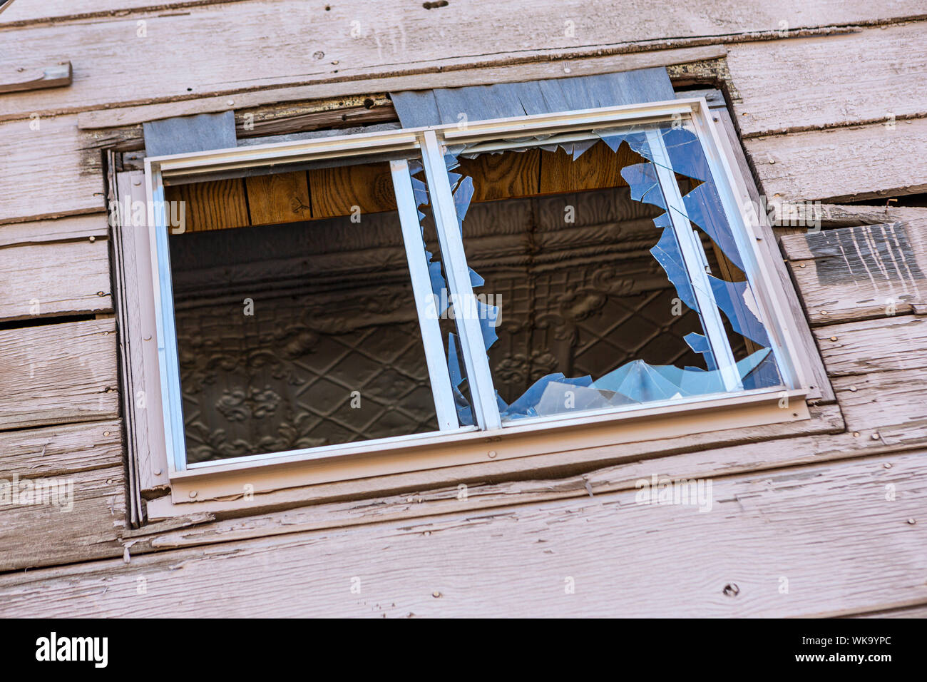 A broken window in a derelict building Stock Photo - Alamy