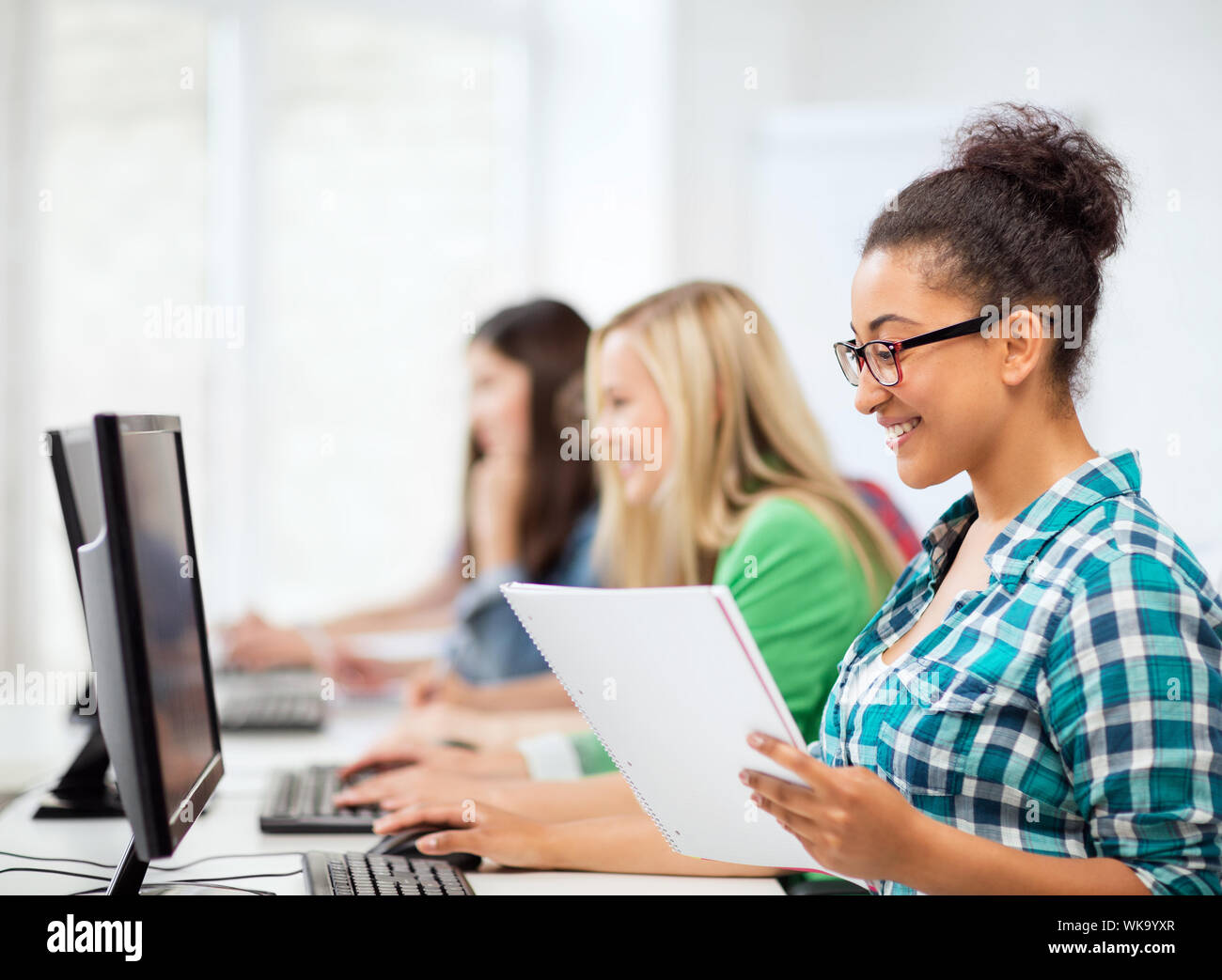 education concept - african student with computer studying at school ...