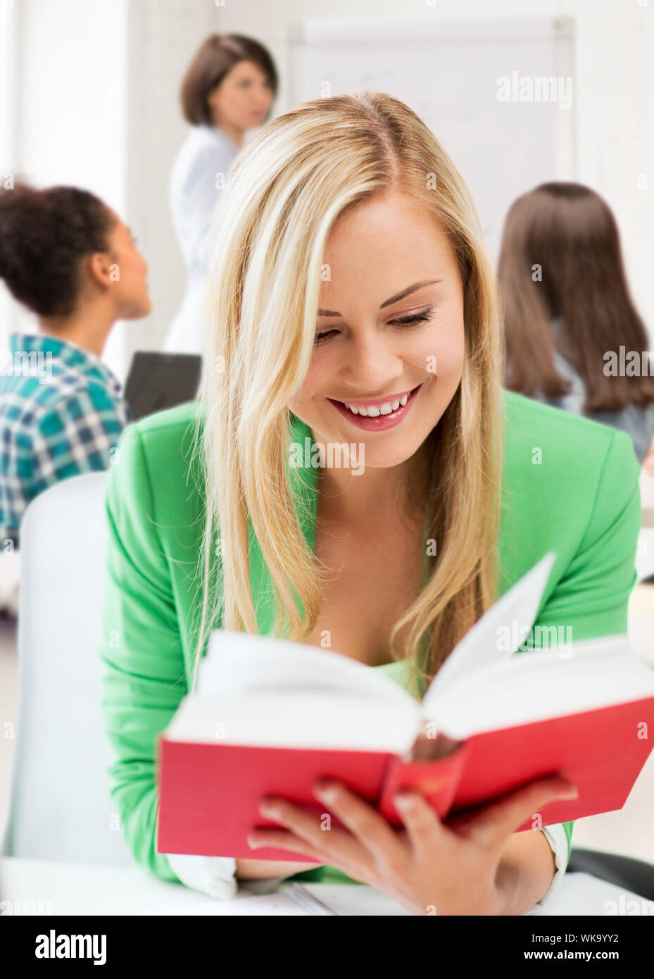 education concept - smiling student girl reading book at school Stock ...