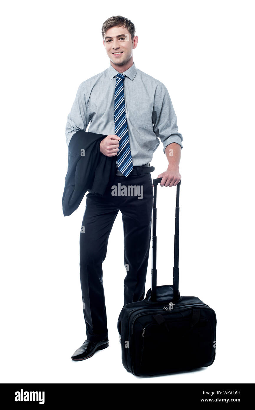 Happy young man holding his luggage in full length pose Stock Photo - Alamy