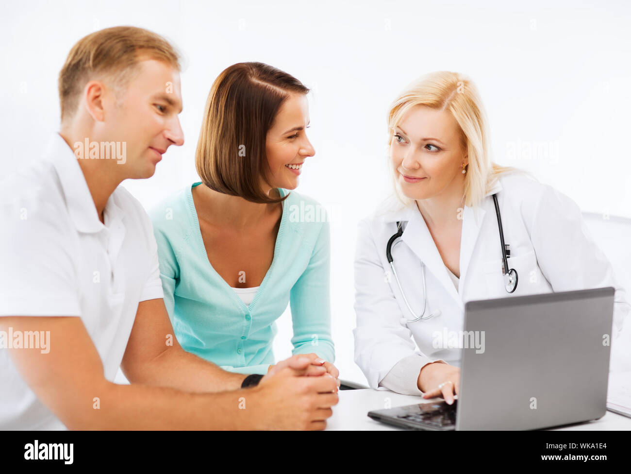doctor with patients looking at laptop Stock Photo - Alamy