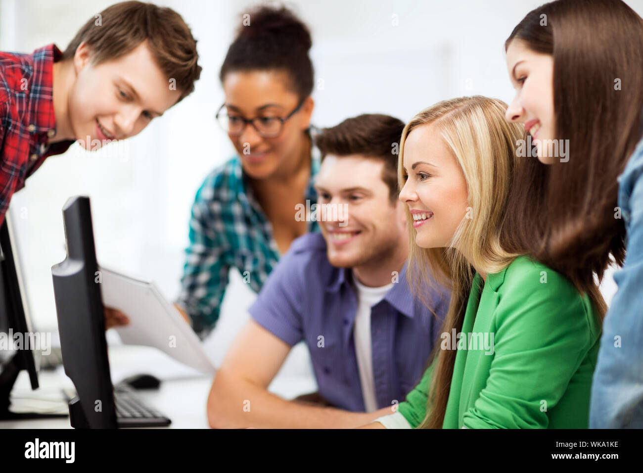students looking at computer monitor at school Stock Photo - Alamy