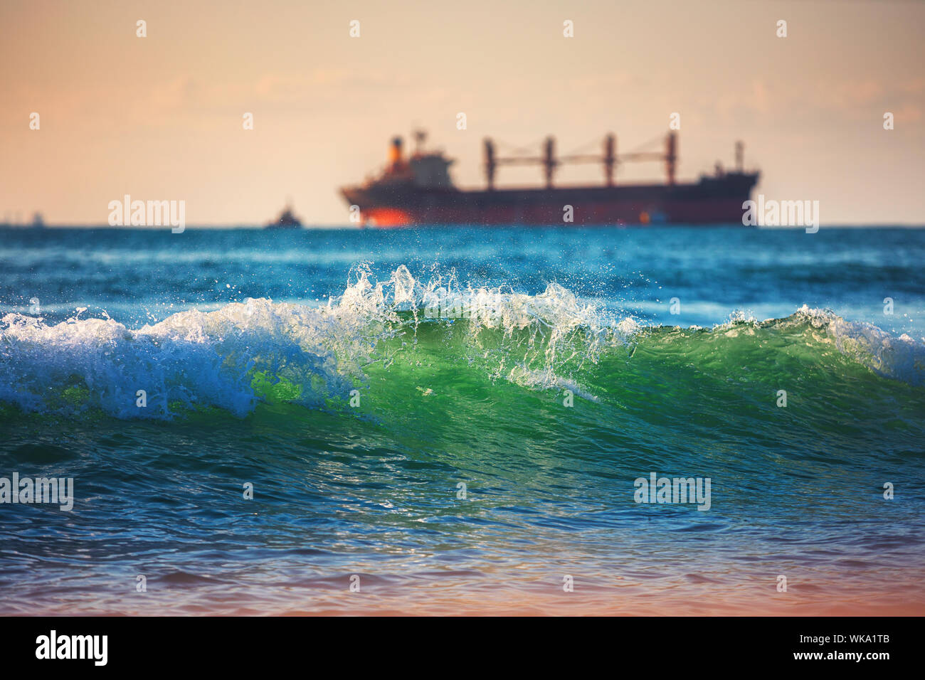 Sailing cargo ship and waves at sunrise. Transportation. Logistics ...