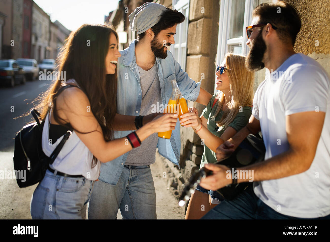 Group of friends having fun and hanging out outdoors Stock Photo - Alamy