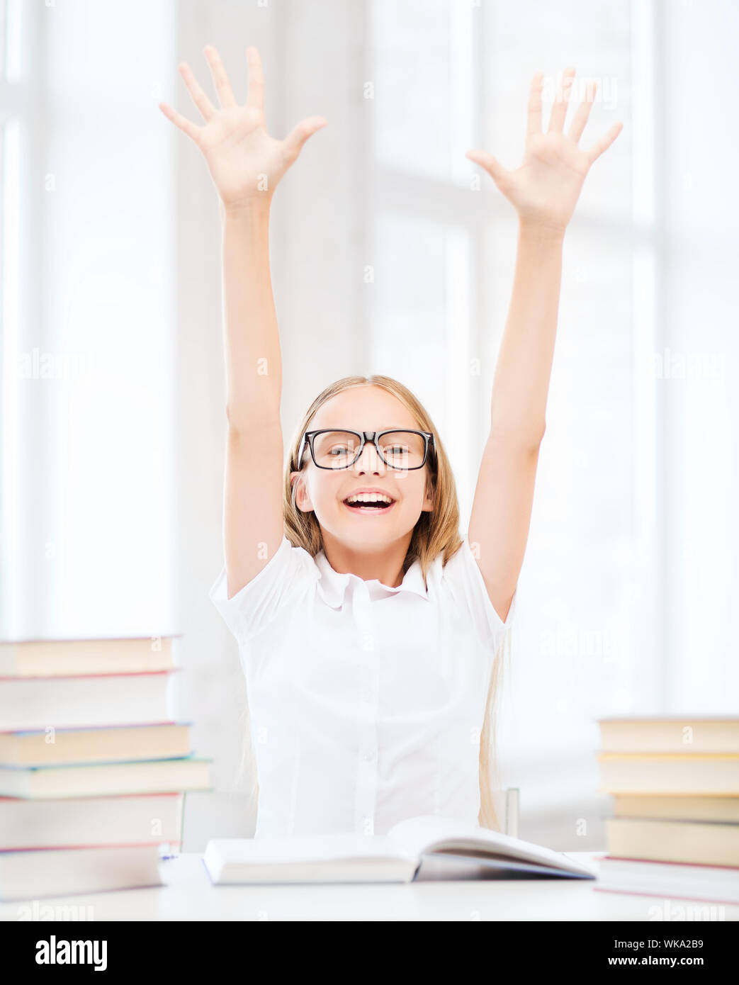 girl with books and hands up Stock Photo - Alamy