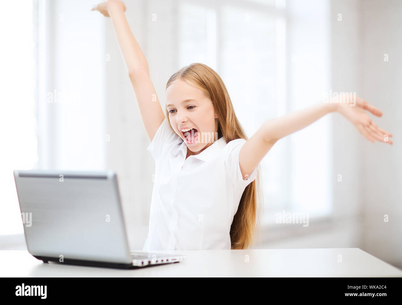 education, school, technology and internet concept - happy little girl ...