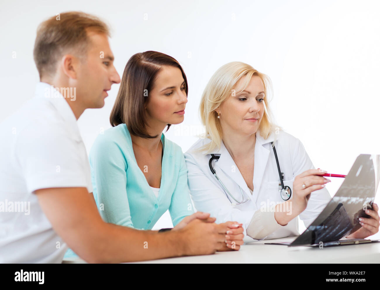 doctor with patients looking at x-ray Stock Photo - Alamy