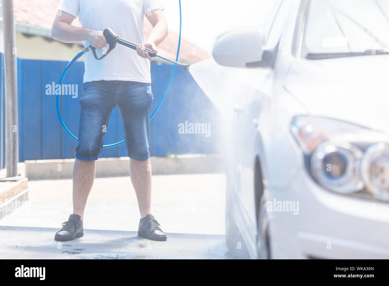 Man washing car wheel with high pressure machine for car wash Stock ...