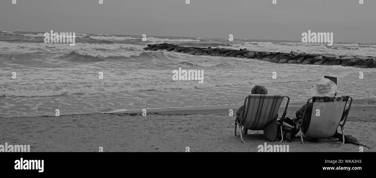 People Sitting In Beach Chairs High Resolution Stock Photography and ...