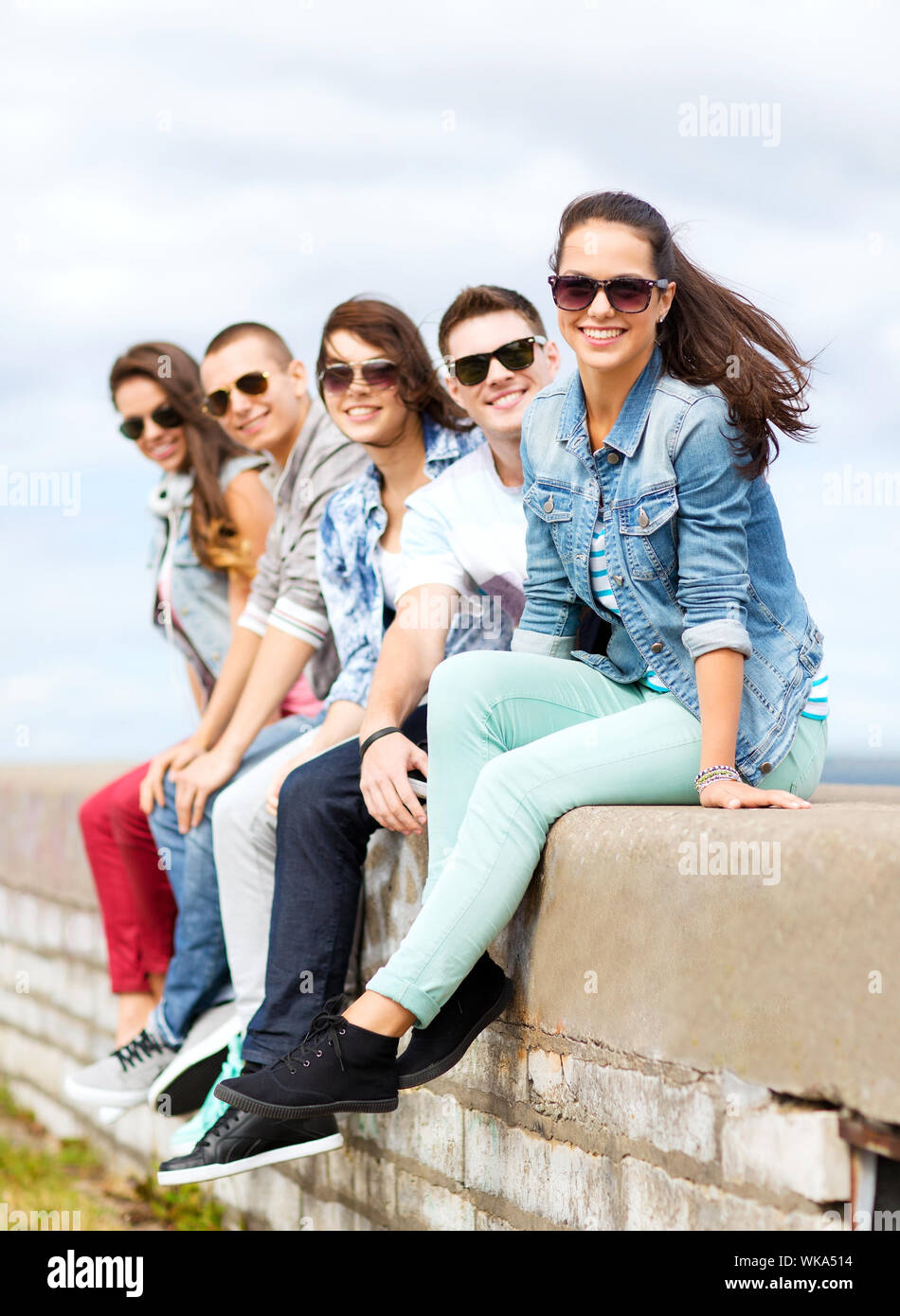 summer holidays and teenage concept - group of teenagers hanging out ...