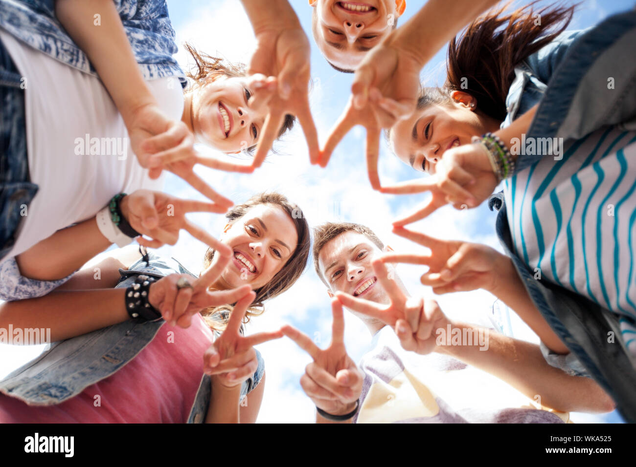 group of teenagers showing finger five Stock Photo - Alamy