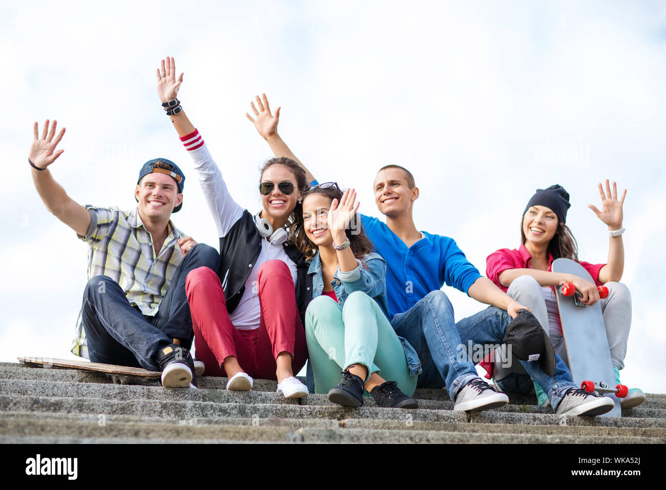 group of teenagers waving hands Stock Photo - Alamy