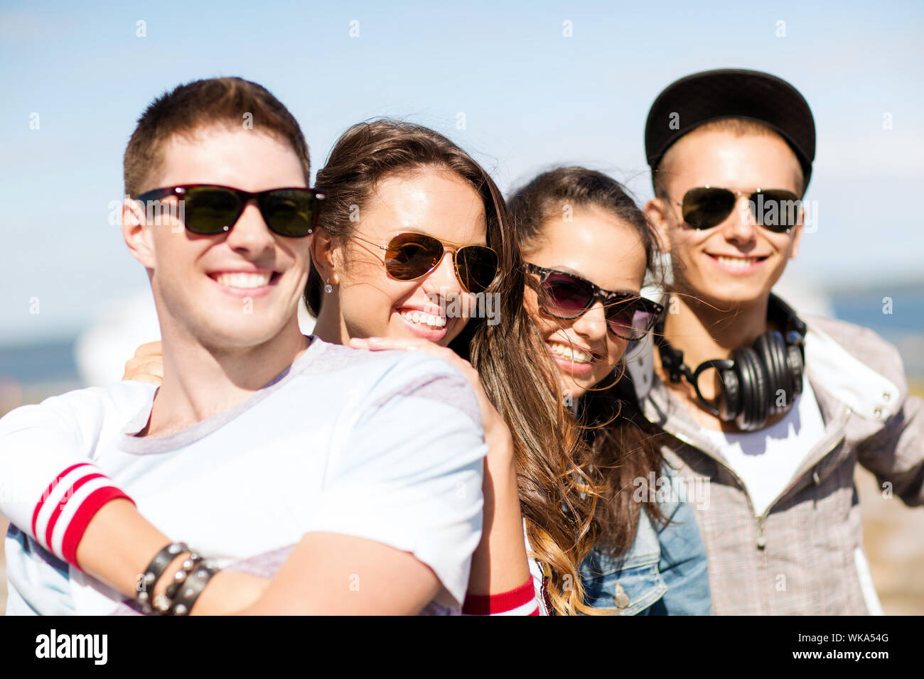 summer holidays and teenage concept - group of teenagers hanging out ...