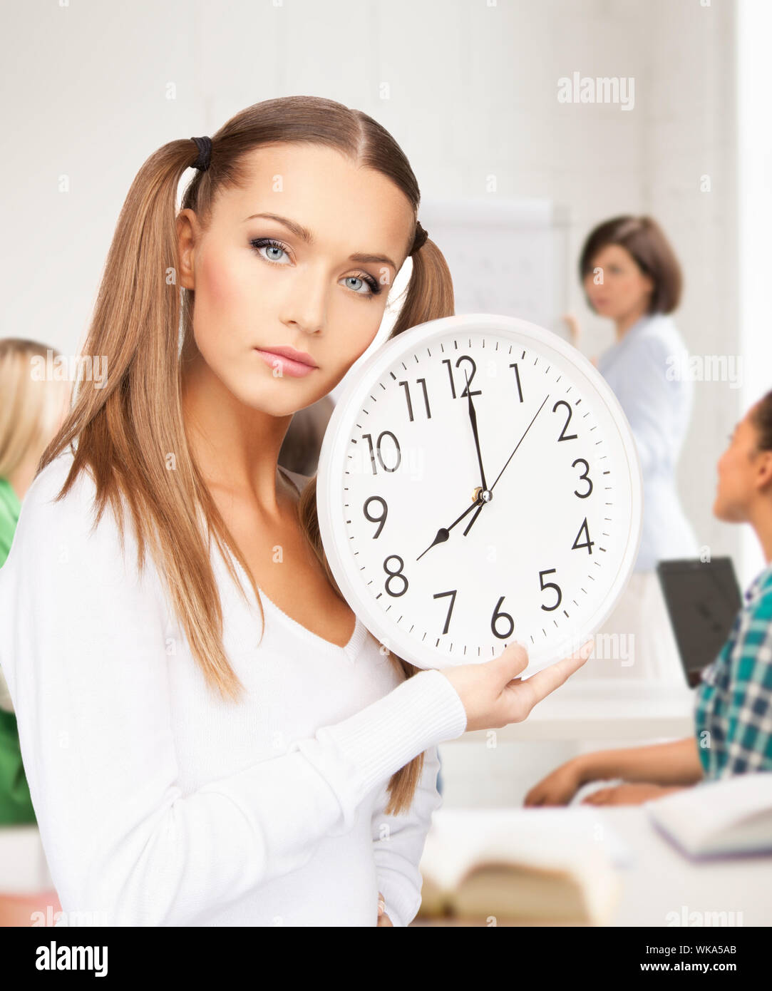 student showing clock Stock Photo - Alamy