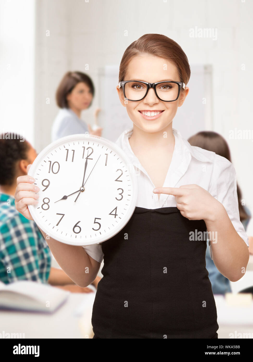 student showing clock Stock Photo - Alamy