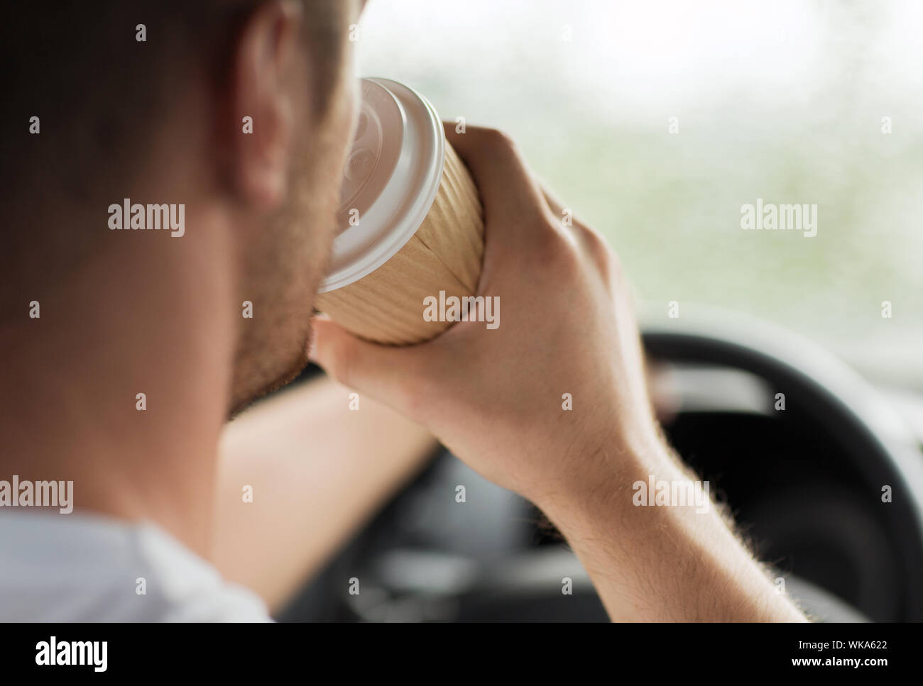 man drinking coffee while driving the car Stock Photo - Alamy
