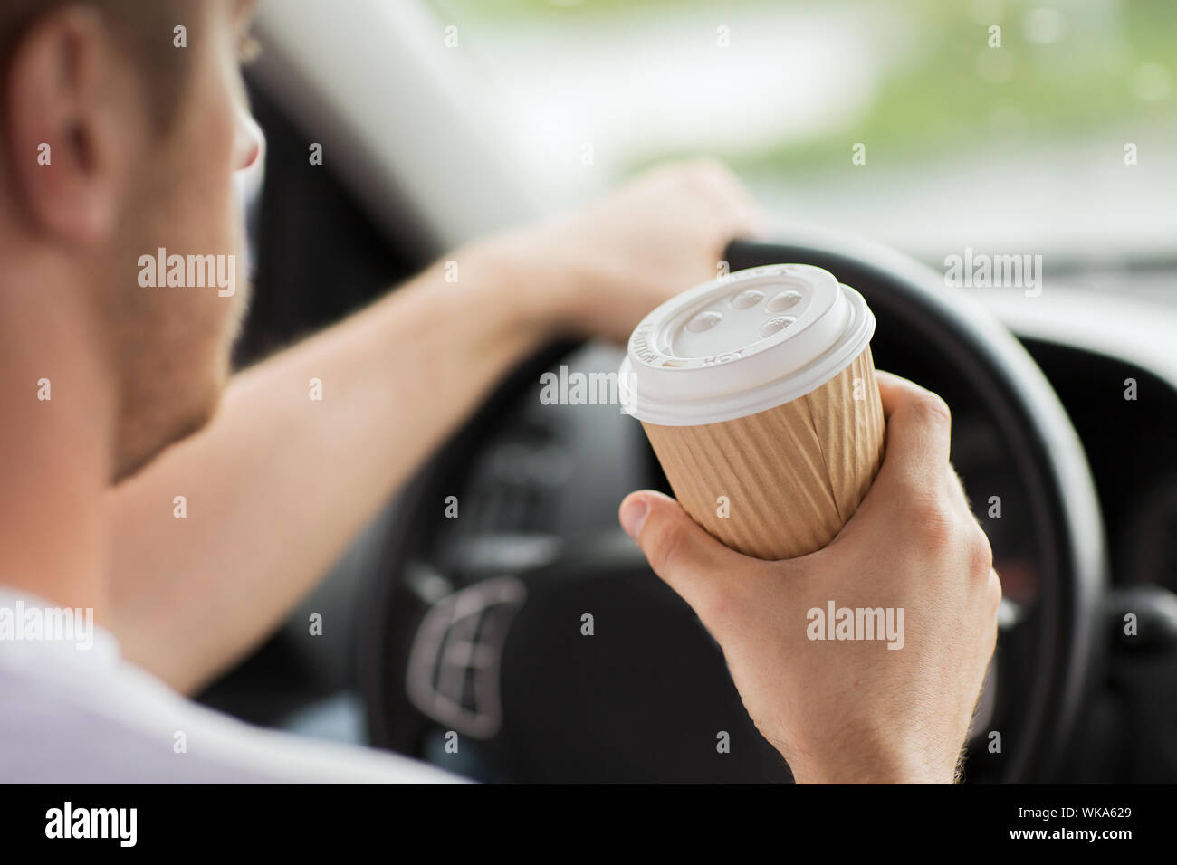 man drinking coffee while driving the car Stock Photo - Alamy