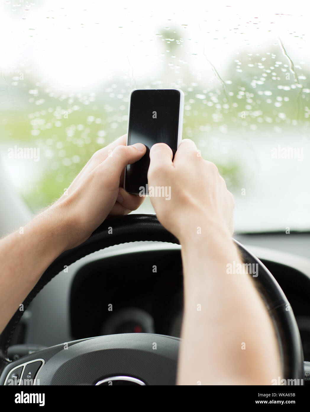 transportation and vehicle concept - man using phone while driving the ...