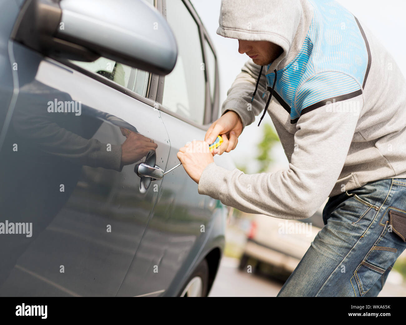 transportation, crime and ownership concept - thief stealing bag from ...