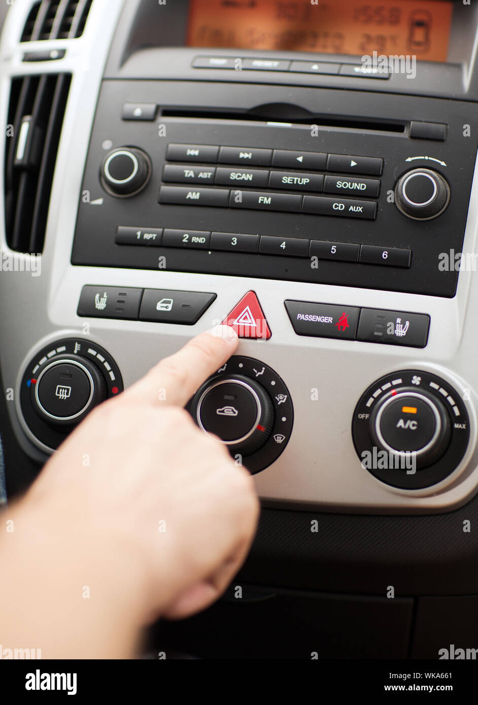 man pressing car hazard warning button Stock Photo - Alamy